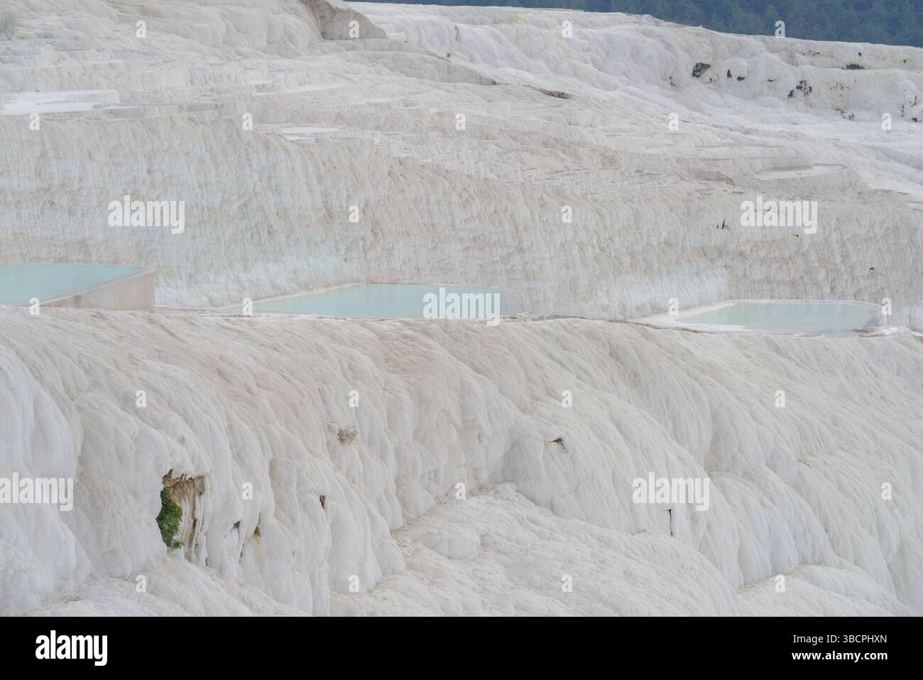 Layers of travertines form terraces of carbonate minerals in Pamukkale ...