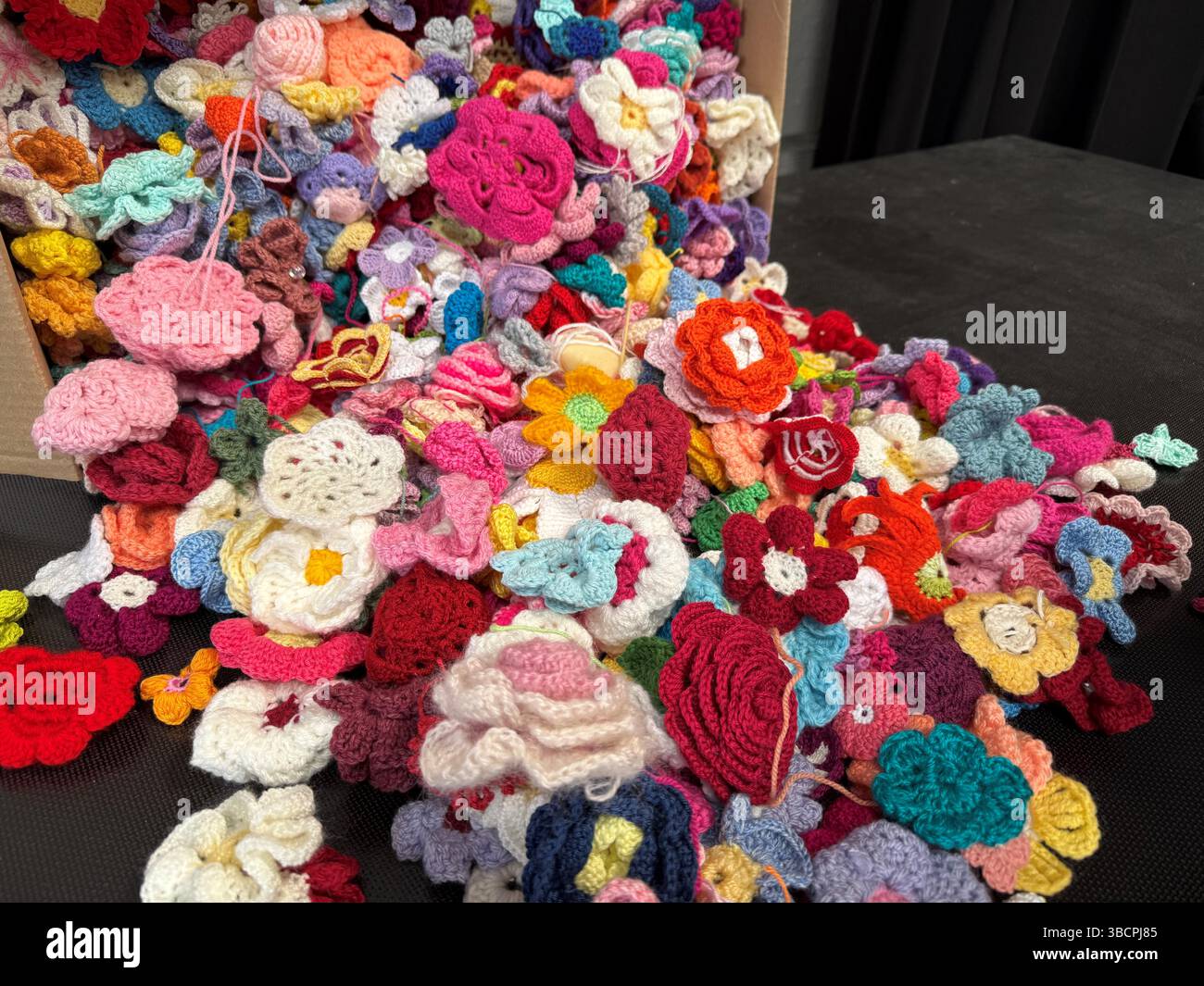 Hanau, Germany. 21st May, 2025. Countless crocheted flowers are ...