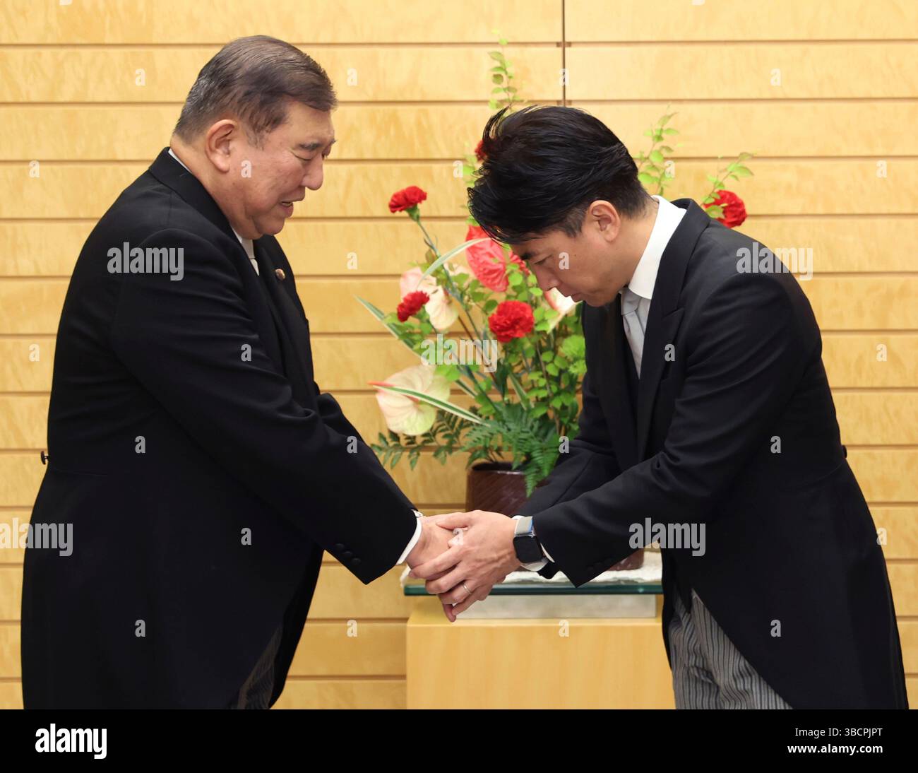 Japanese newly appointed Agriculture Minister Shinjiro Koizumi (R ...