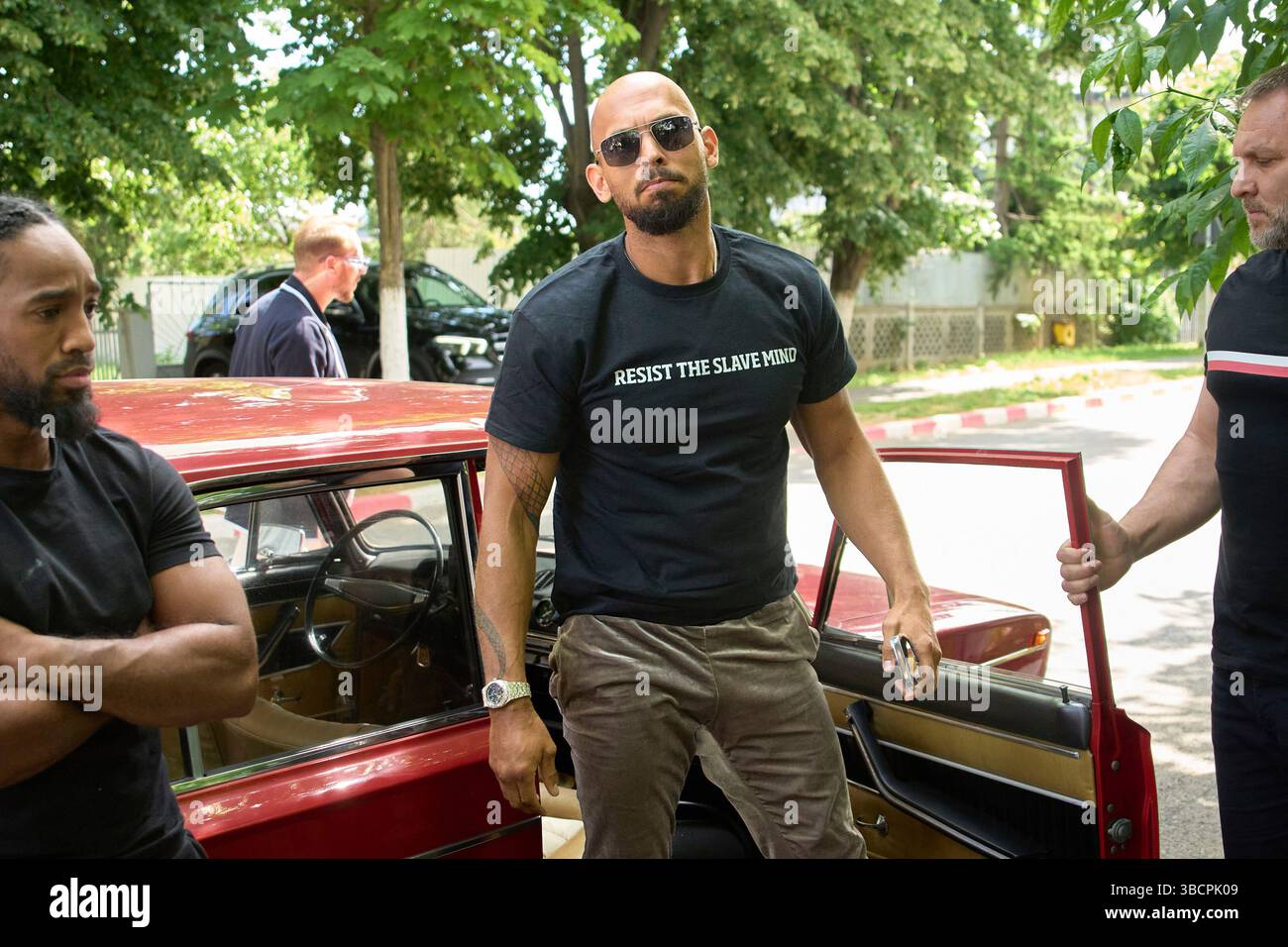 Andrew Tate arrives at a police station in a Lada vehicle in Voluntari ...