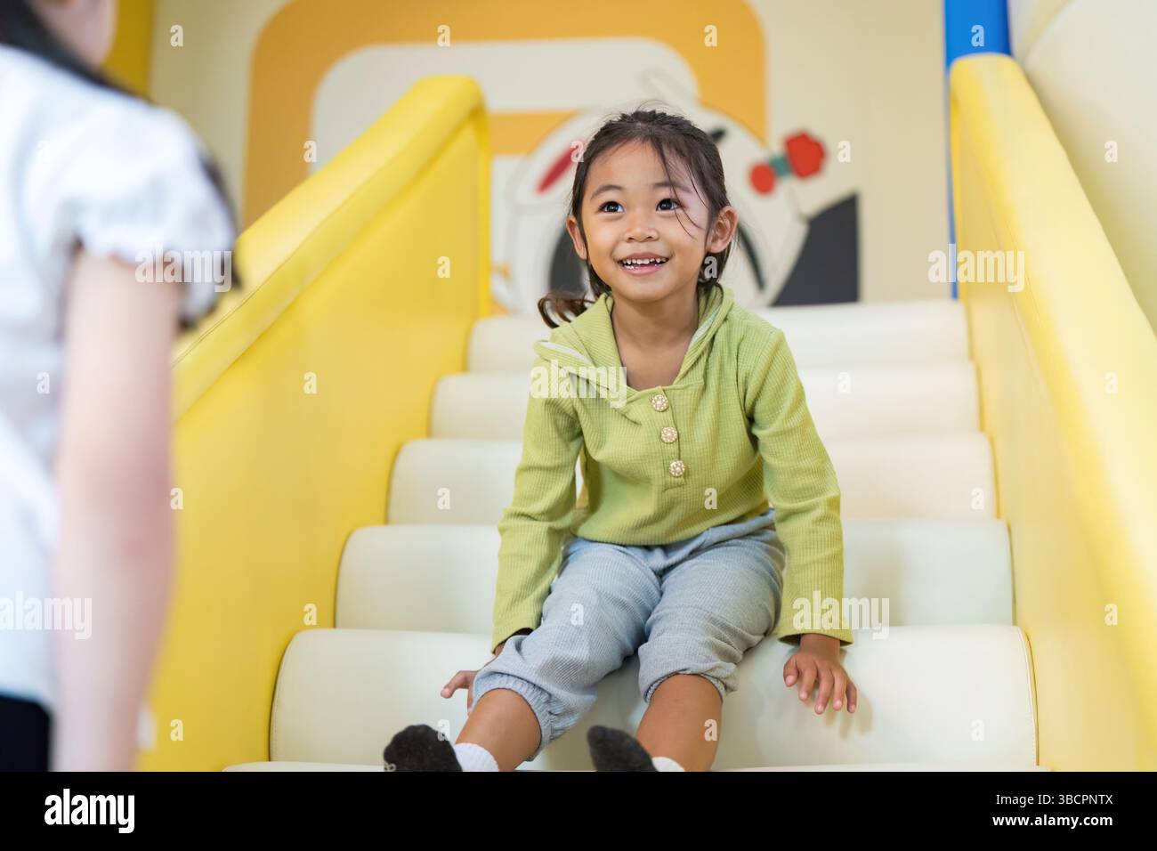 Child on Slide Steps. Happy girl preparing to slide down at colorful ...