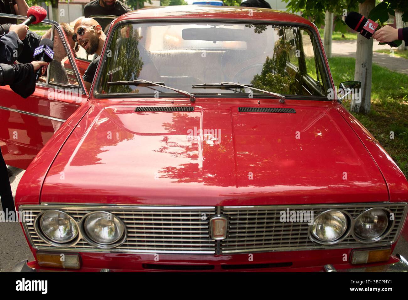 Andrew Tate leaves a police station in a Lada vehicle in Voluntari ...