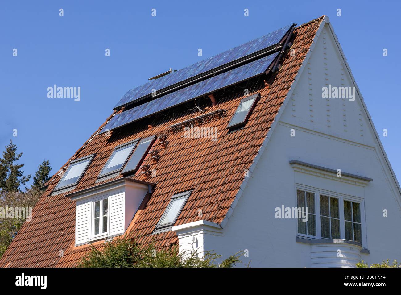 older solar system on the gable roof of an old villa Stock Photo - Alamy