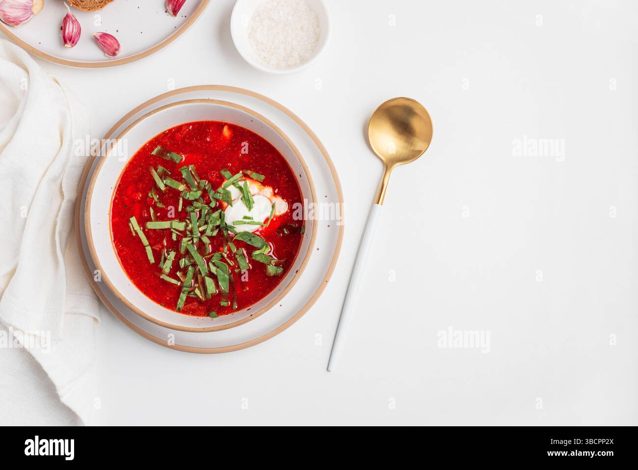 Traditional Ukrainian borscht with sour cream, garlic and rye bread on ...
