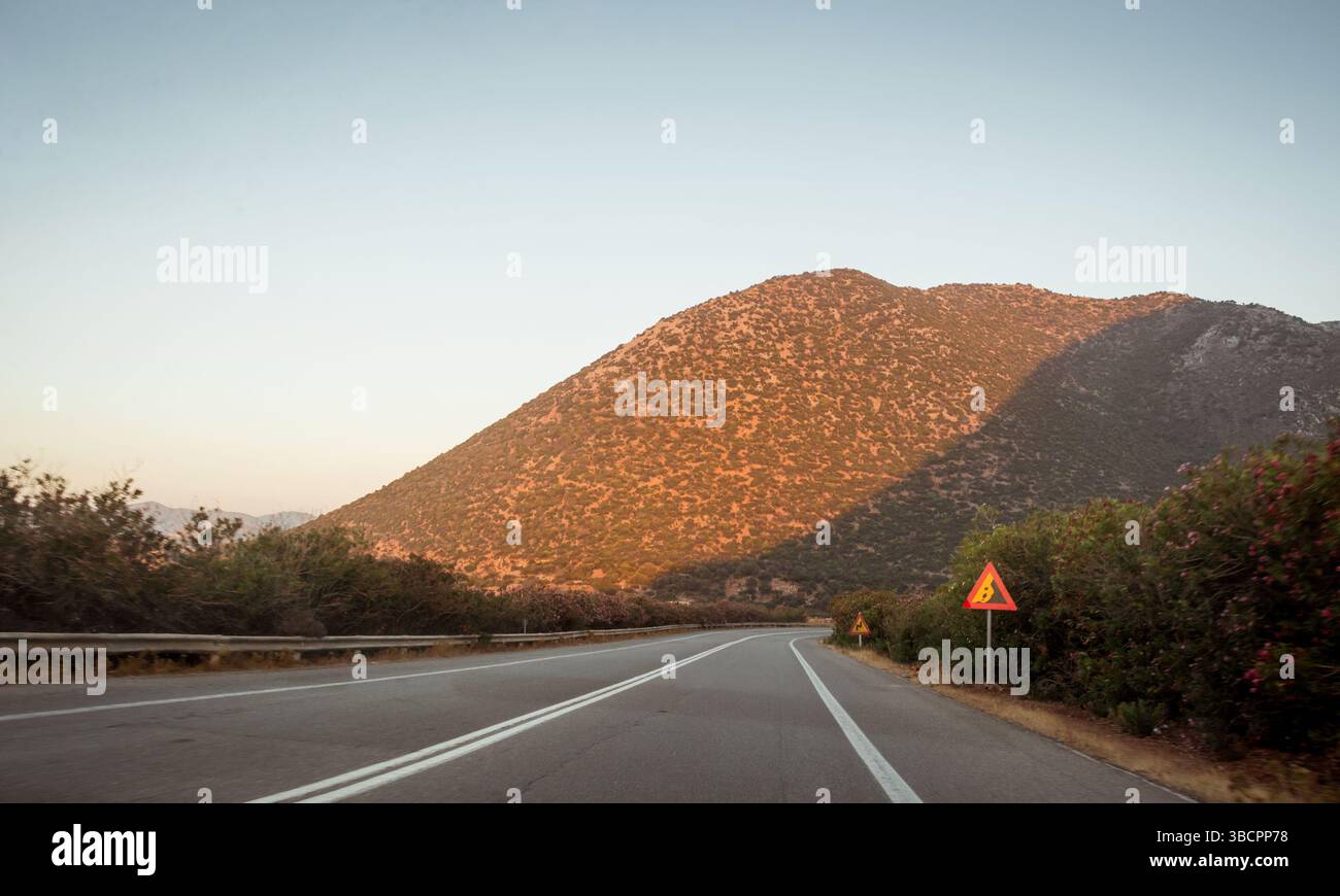 Driving in northern Crete. Empty mountain pass at sunset - driver's ...