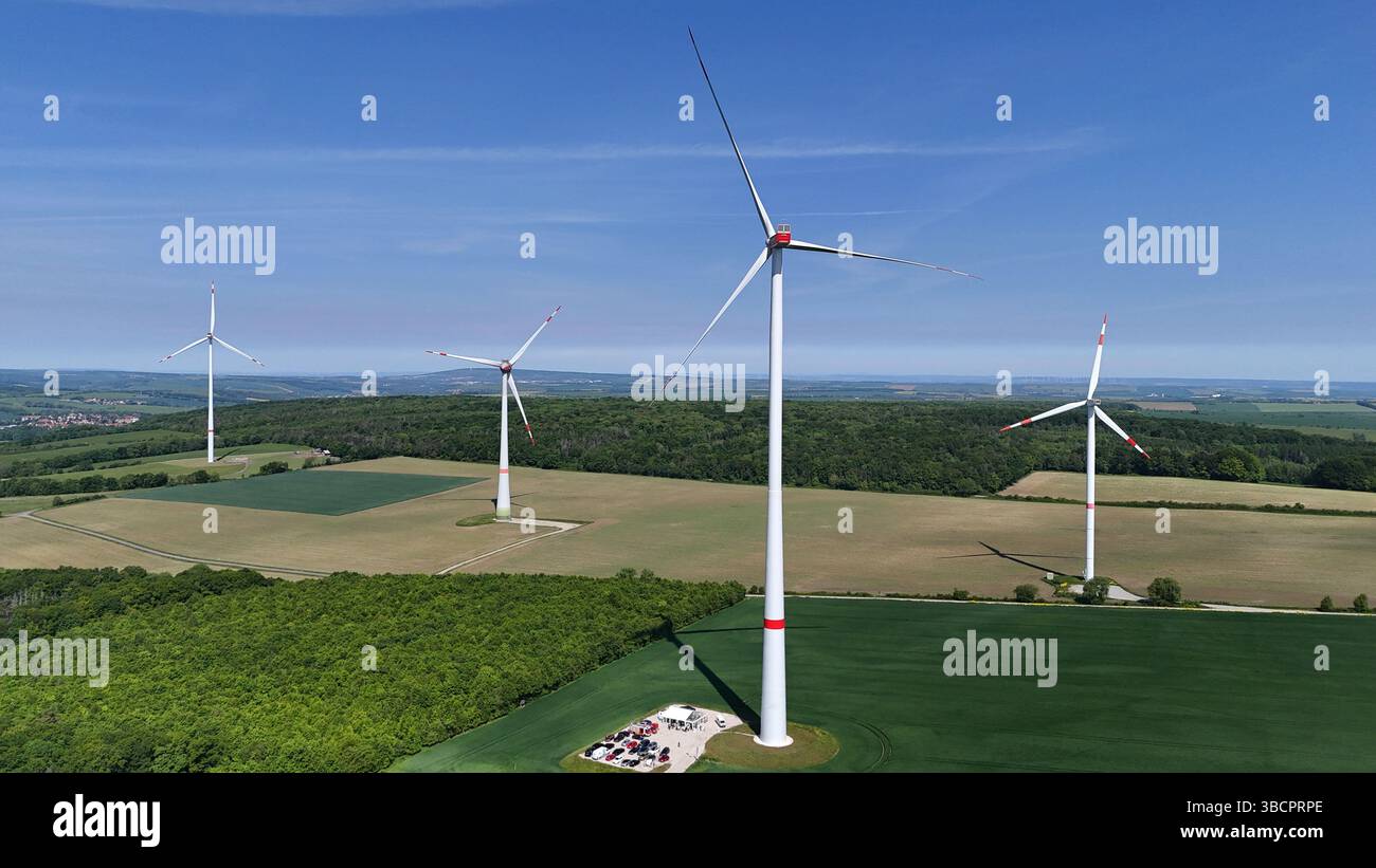 21 May 2025, Thuringia, Coppanz: Wind turbines turning in a refurbished ...
