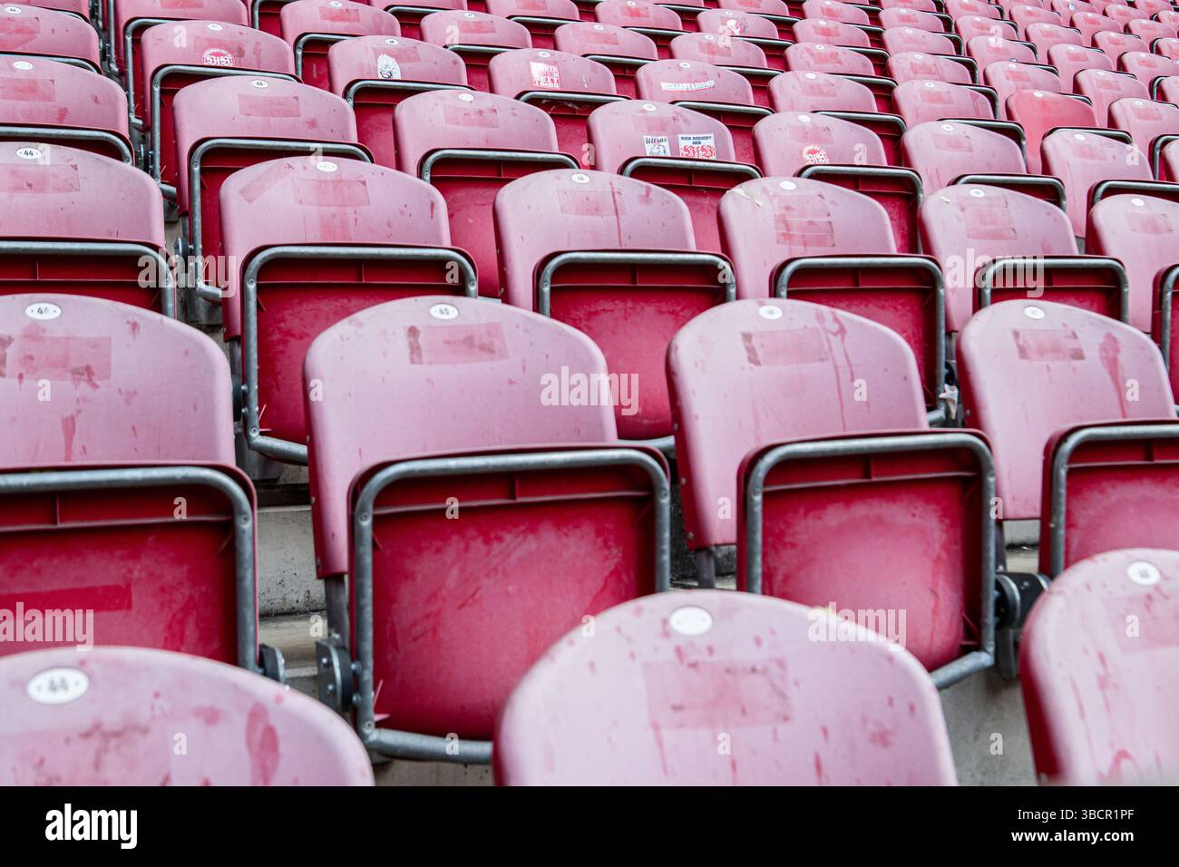 MAINZ, GERMANY - 17 MAY, 2025: Close-up view of empty red stadium seats ...