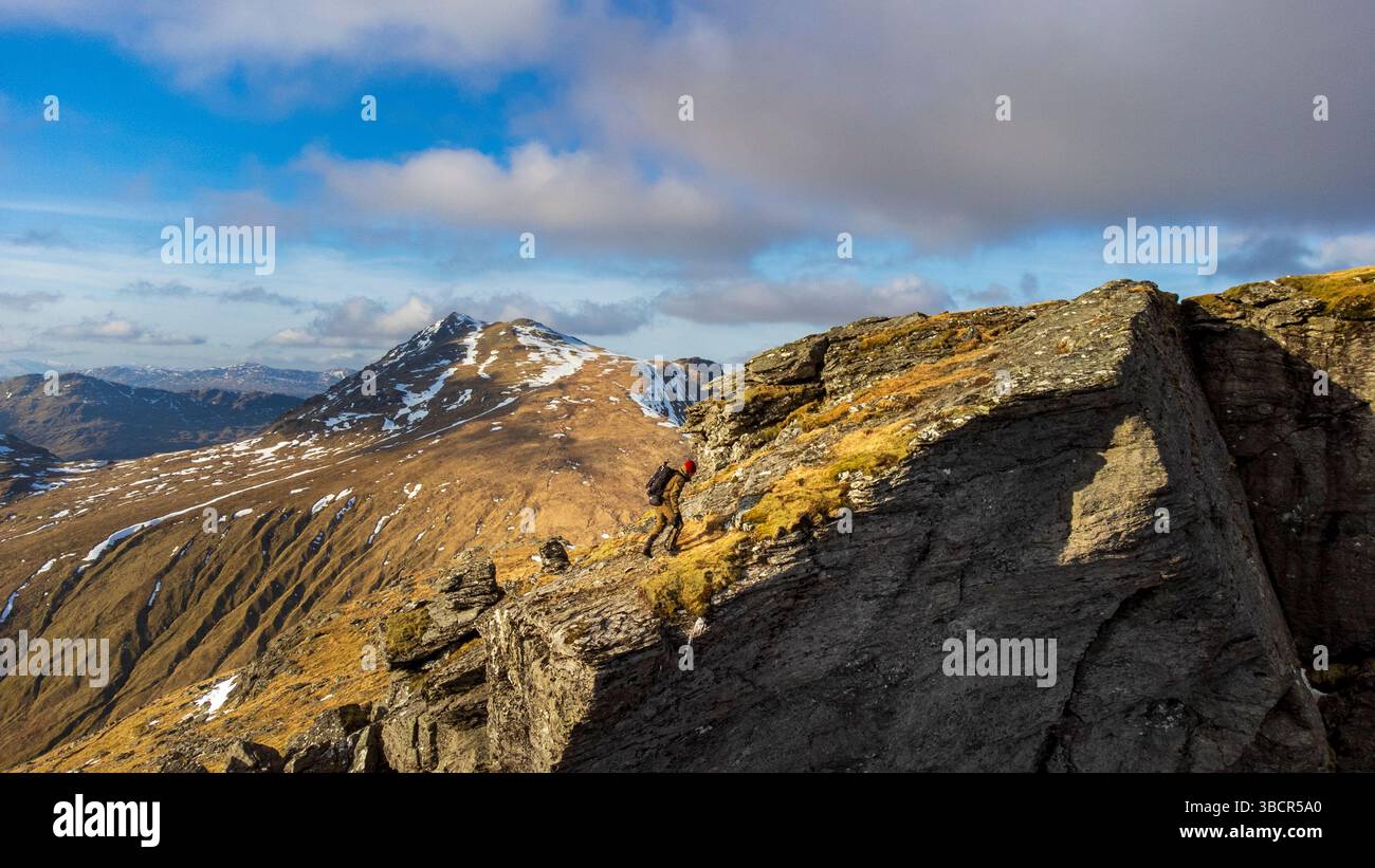 A lone photographer stands atop The Cobbler (Ben Arthur) in Scotland’s ...