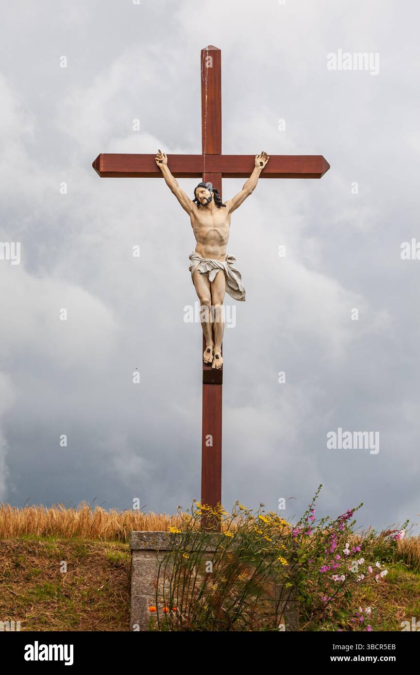 Crucifix, a sculpture of Jesus on a wooden cross on the side of a road ...