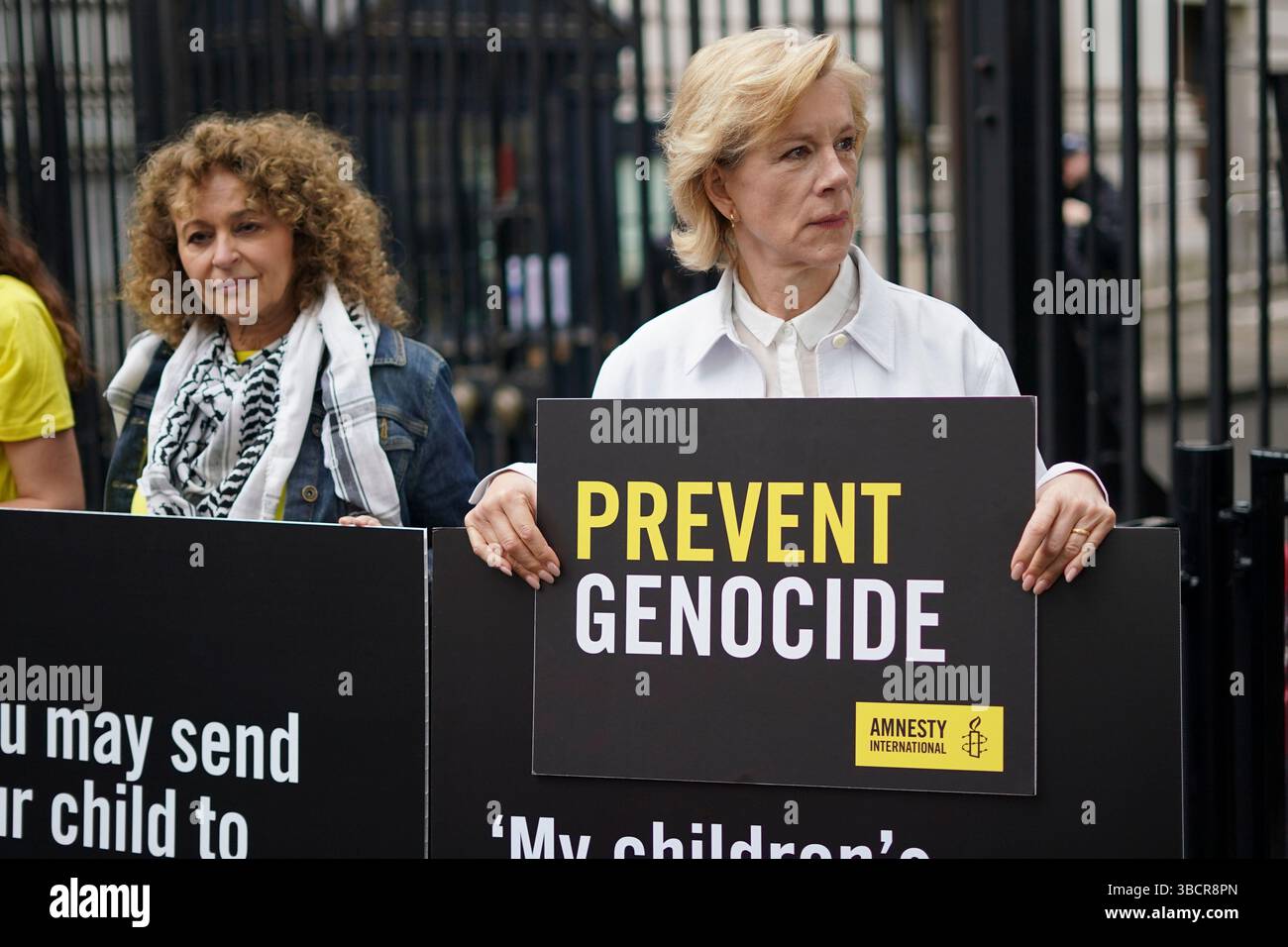 From left to right, Nadia Sawalha and Juliet Stevenson hold placards ...