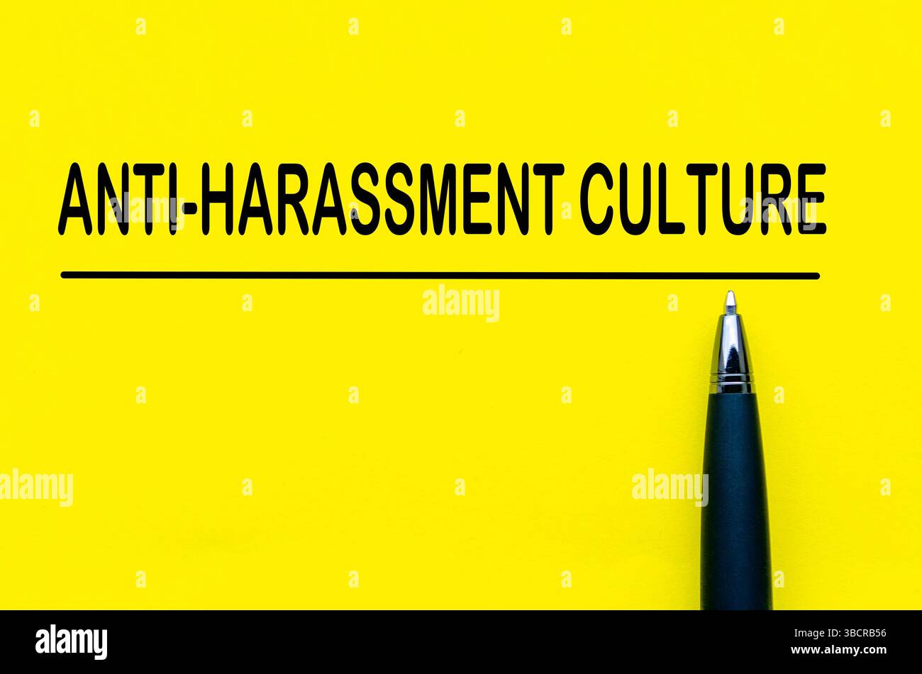 Anti-harassment culture text on yellow lines with pen representing a ...