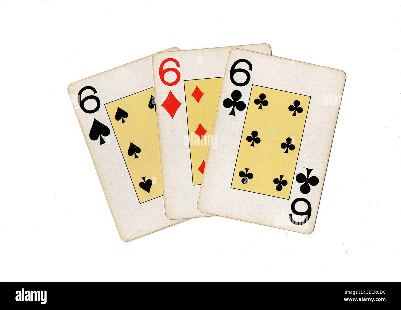 Vintage playing cards showing three of the same value isolated on a ...