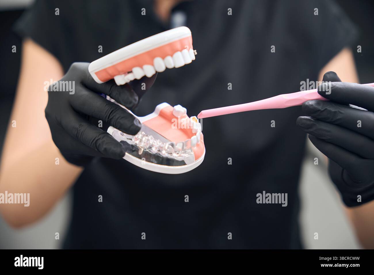 Dental technician using 3d model to show to client destroyed teeth ...