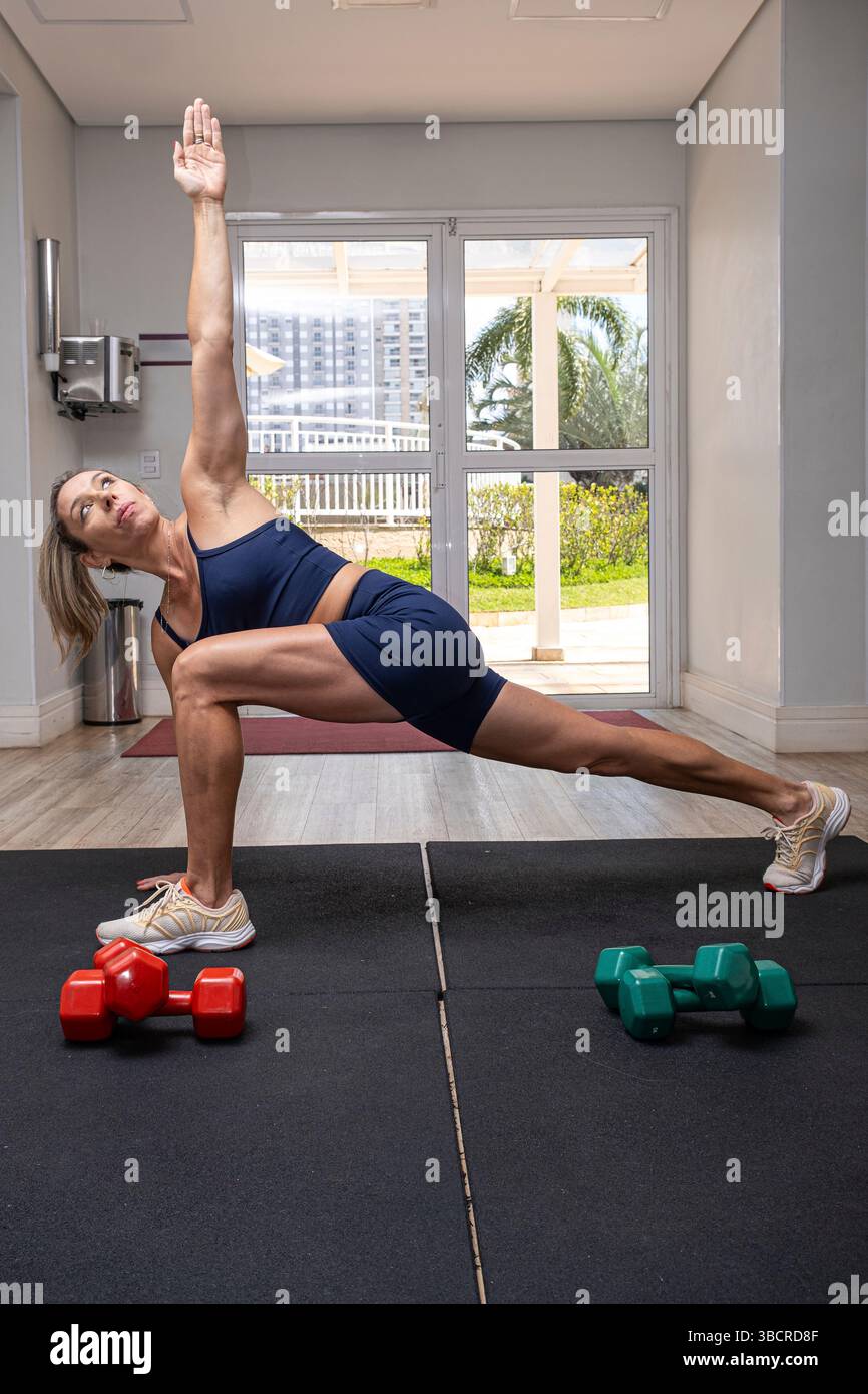 46 year old Brazilian woman doing a hamstring stretch vertical Stock ...