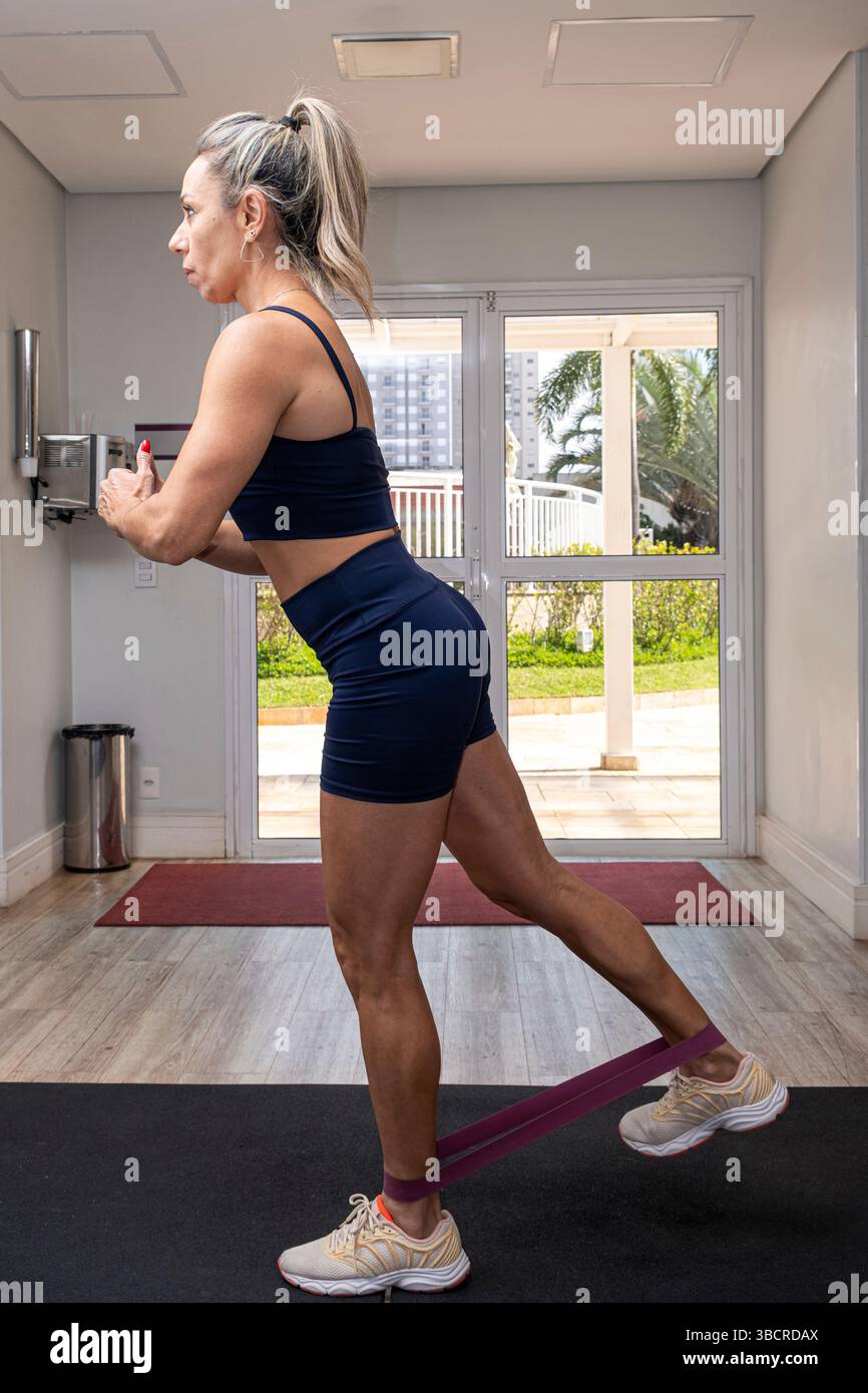 46 year old Brazilian woman doing resistance band exercises for the ...