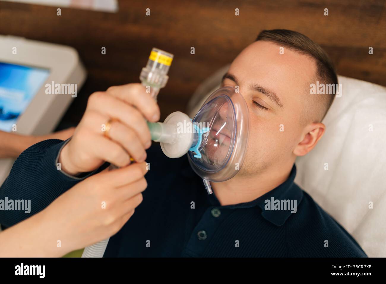 Close-up of medical professional providing oxygen mask during ...