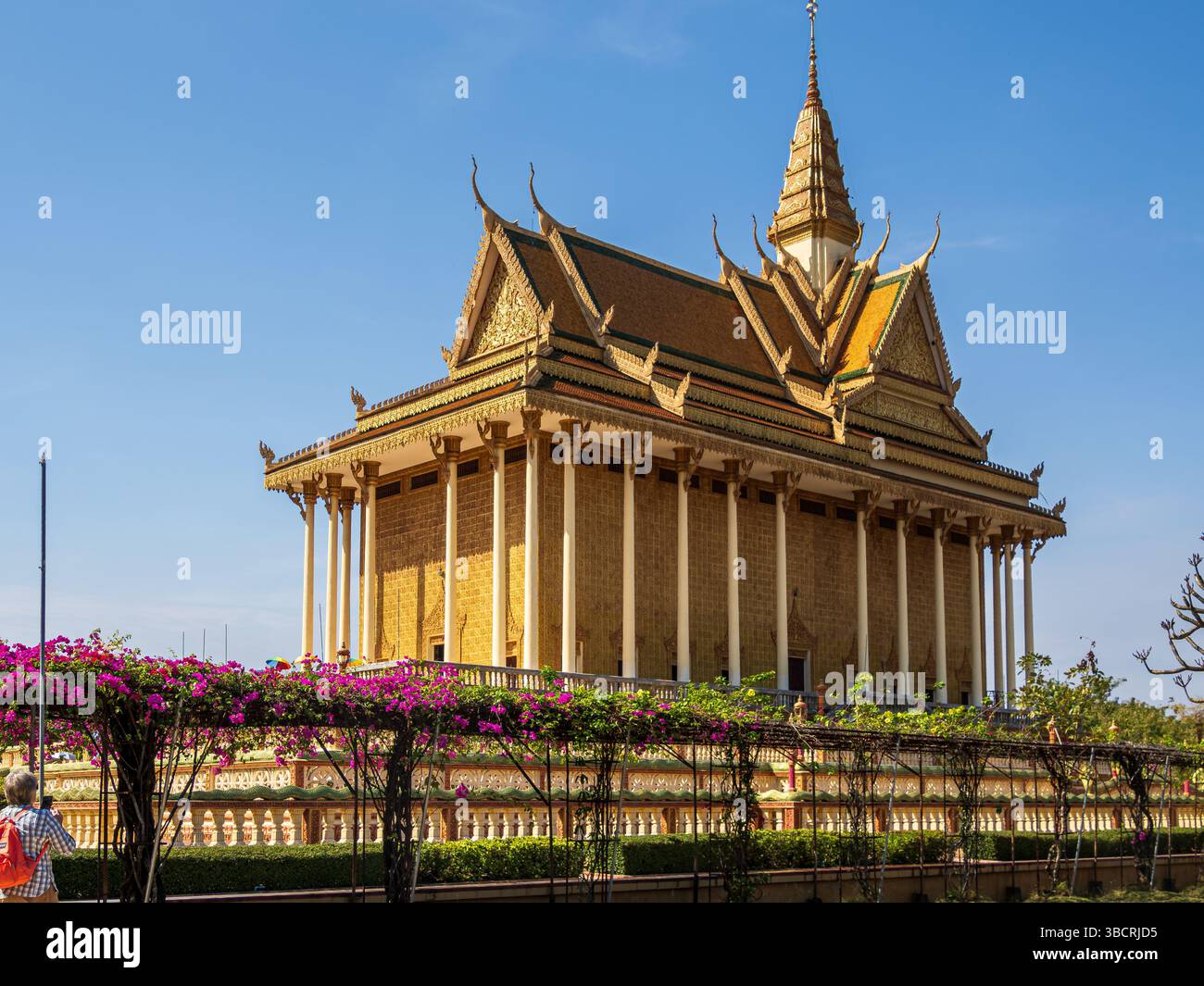 View of the temple and surrounding fence with bougainvillea plants at ...