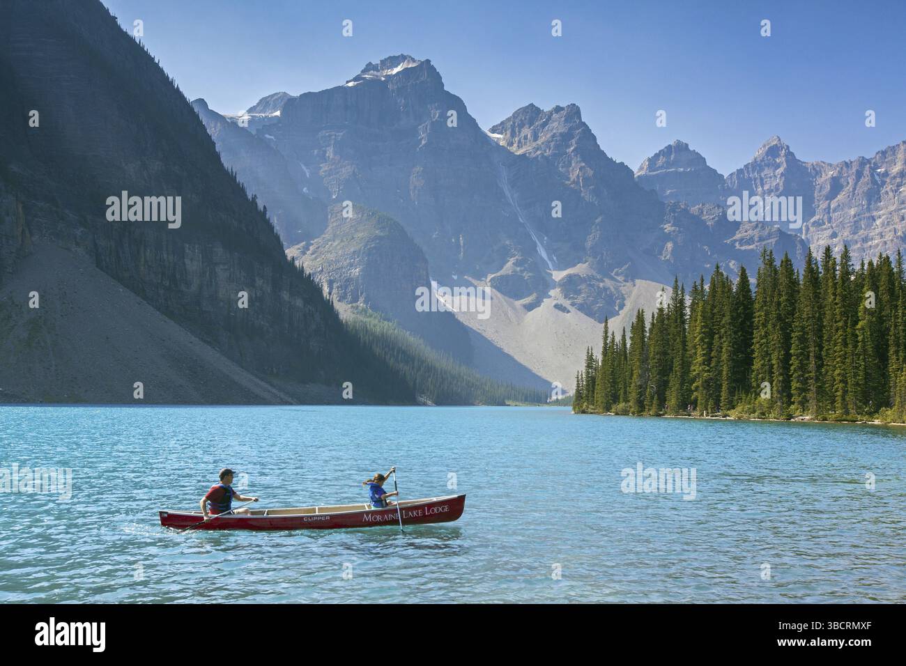 Tourists in canoe on Moraine Lake in the Valley of the Ten Peaks, Banff National Park, Alberta ...