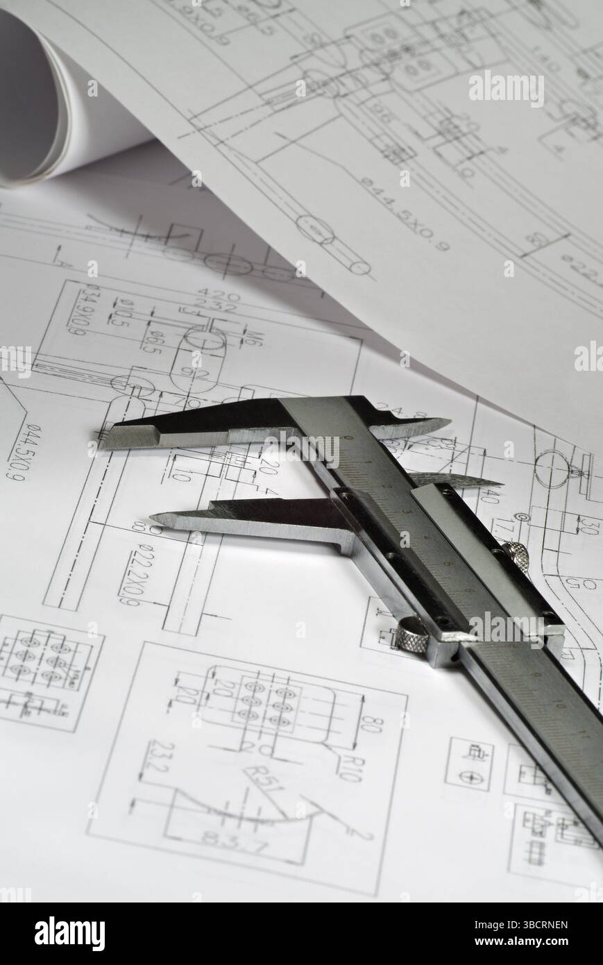 Vernier calliper and design blueprints Stock Photo - Alamy
