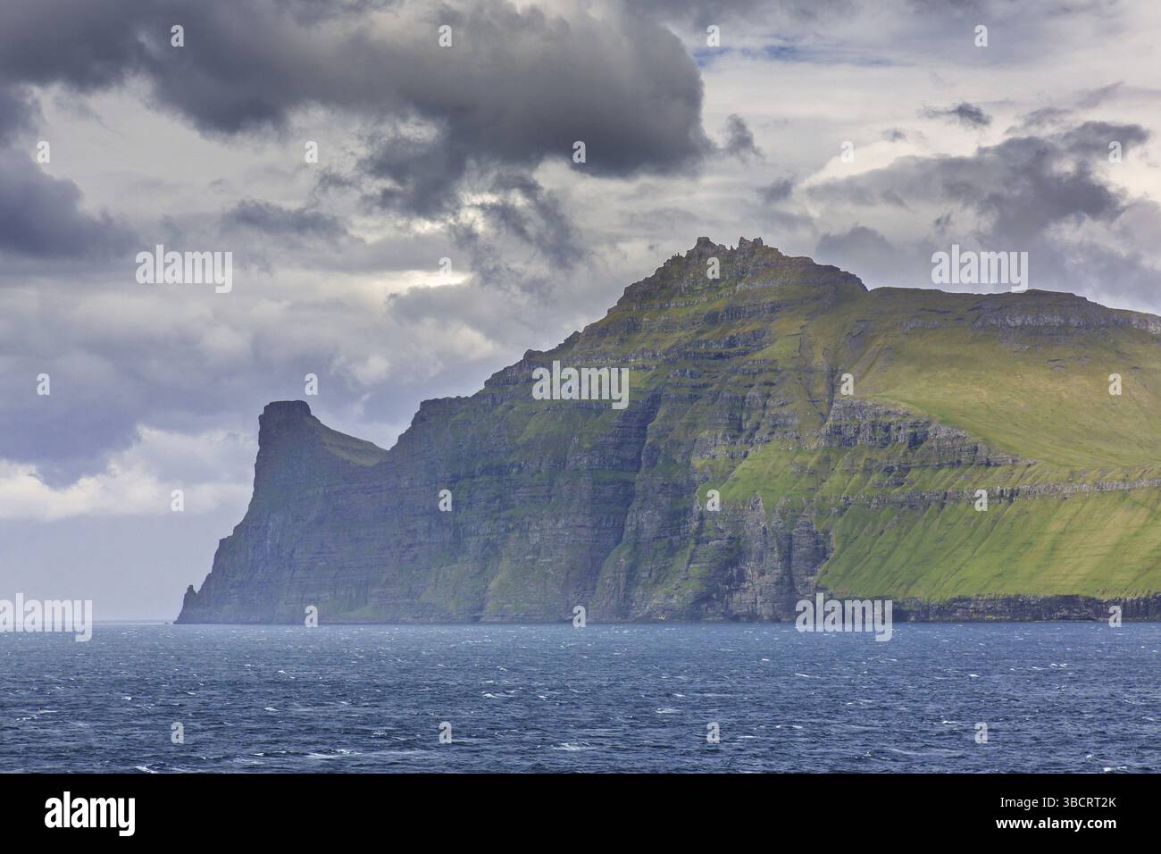 Sea cliffs along the rugged coast of Eysturoy, East Island, region and ...