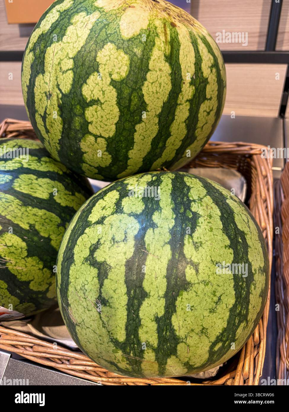 Brightly colored watermelons with distinctive striped patterns are ...