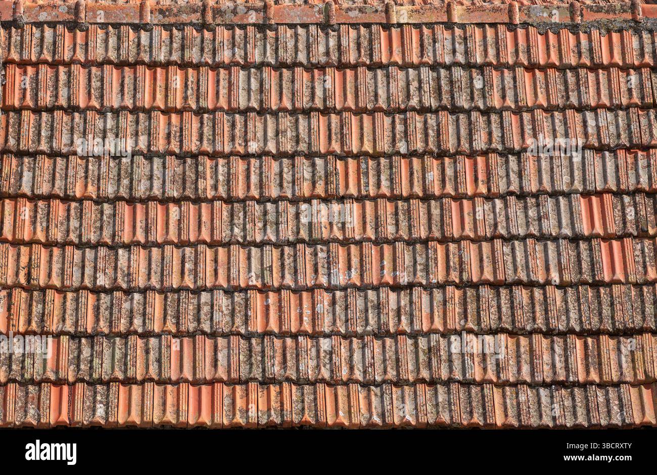 Weathered red roof tiles on an old bent roof surface Stock Photo - Alamy