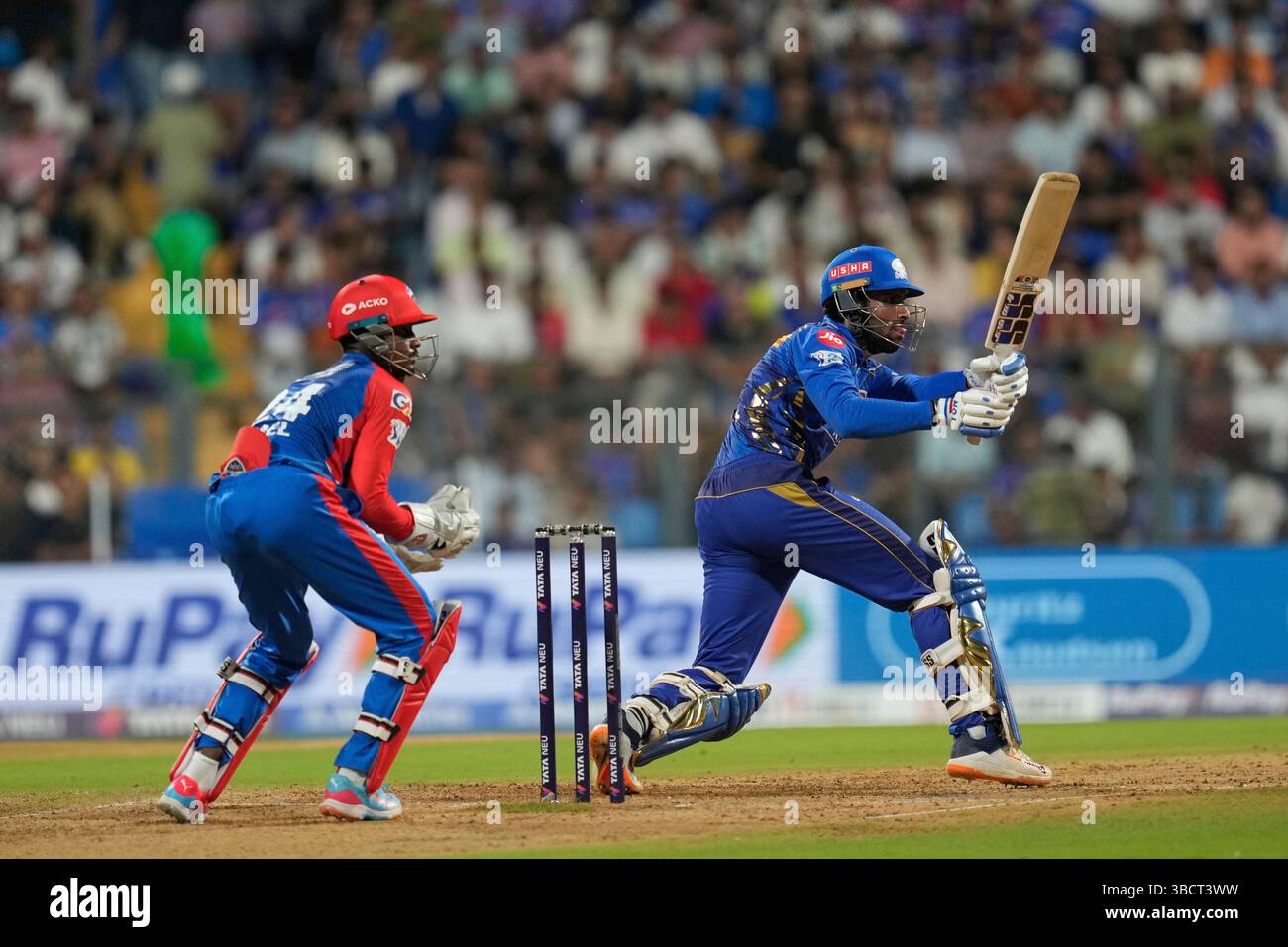 Mumbai Indians' Tilak Verma, right, plays a shot during the Indian ...