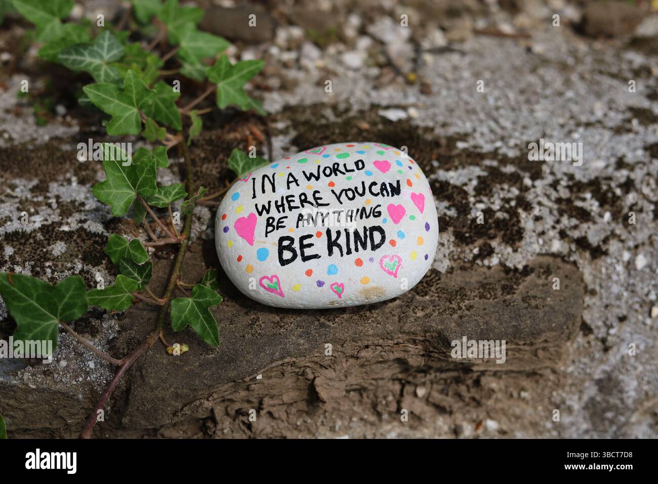 Mossy stone with vine and be kind kindness rock Stock Photo - Alamy