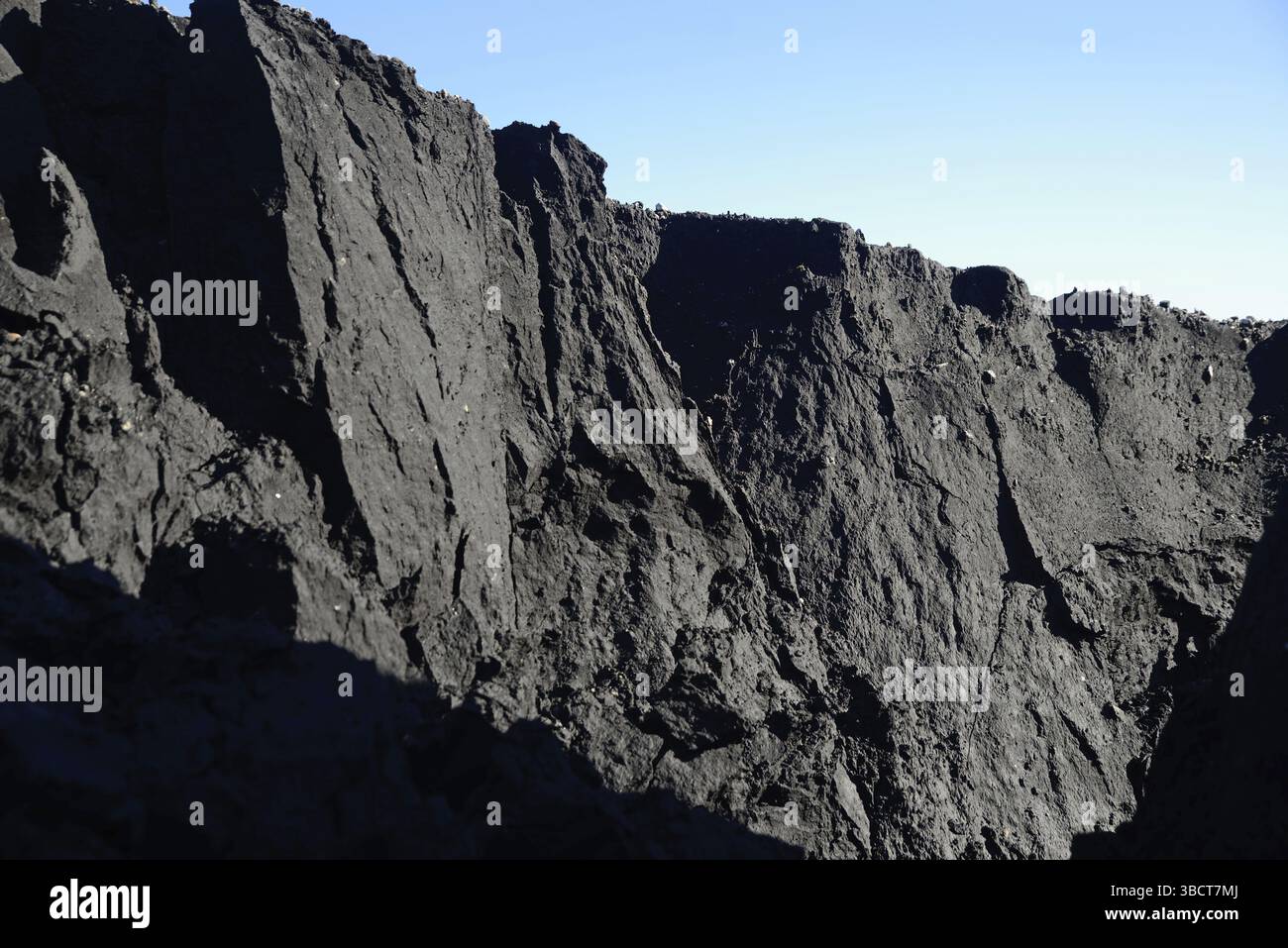 A mountain of coal dust eroded by water at a coal mine Stock Photo - Alamy