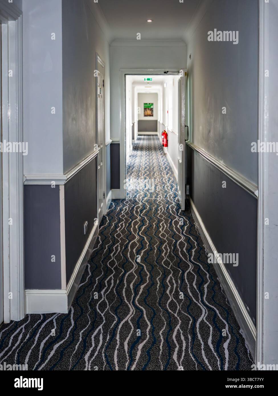 Hotel long corridor with grey carpet. Liminal Space Stock Photo - Alamy