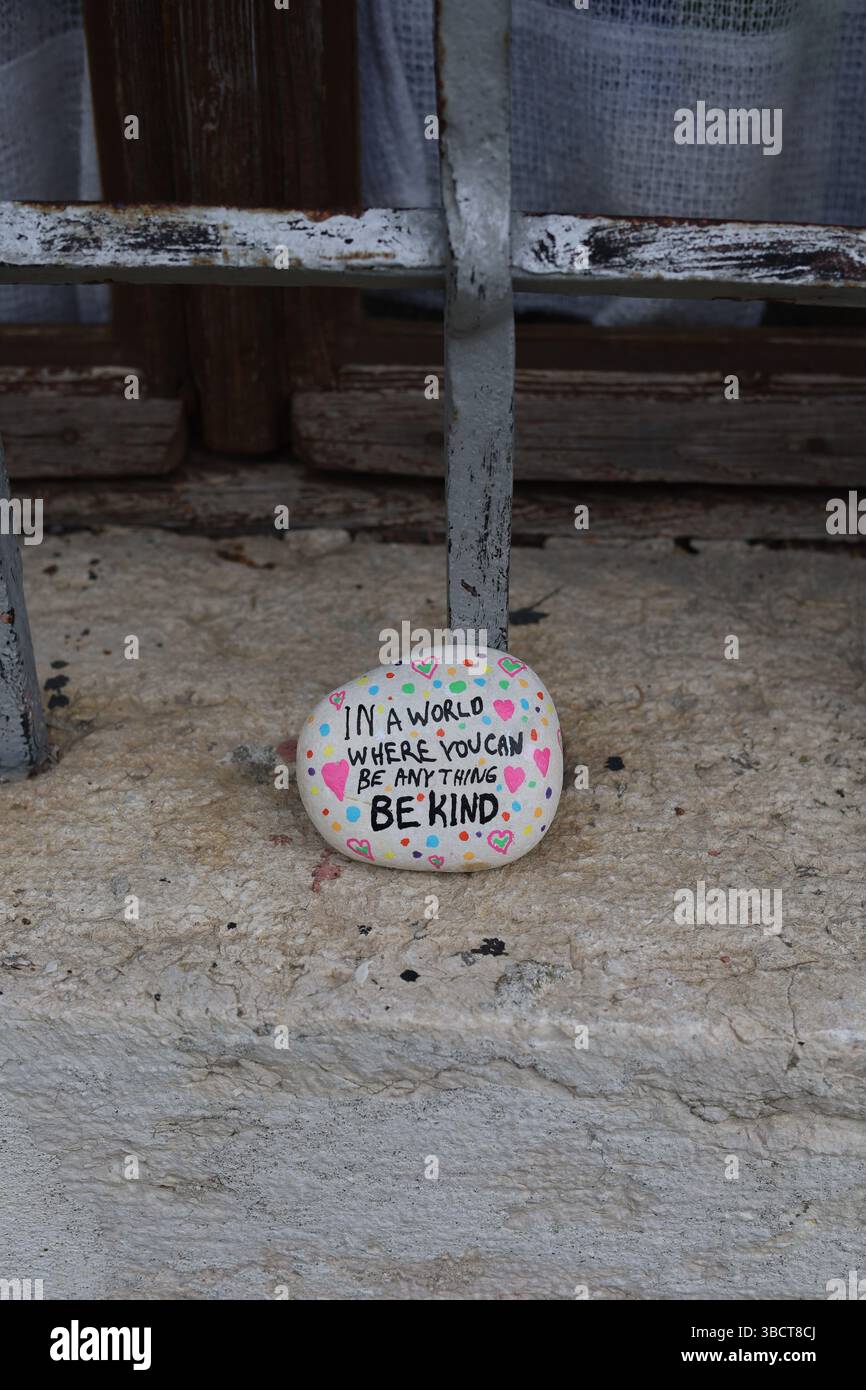 Window with metal bars and be kind kindness rock vertical photo Stock ...