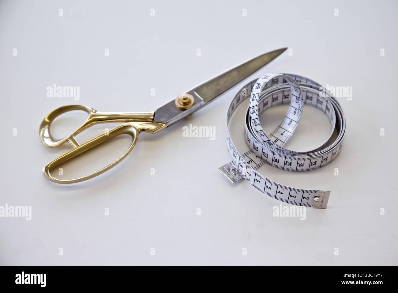 Scissors and a tape measure Stock Photo - Alamy