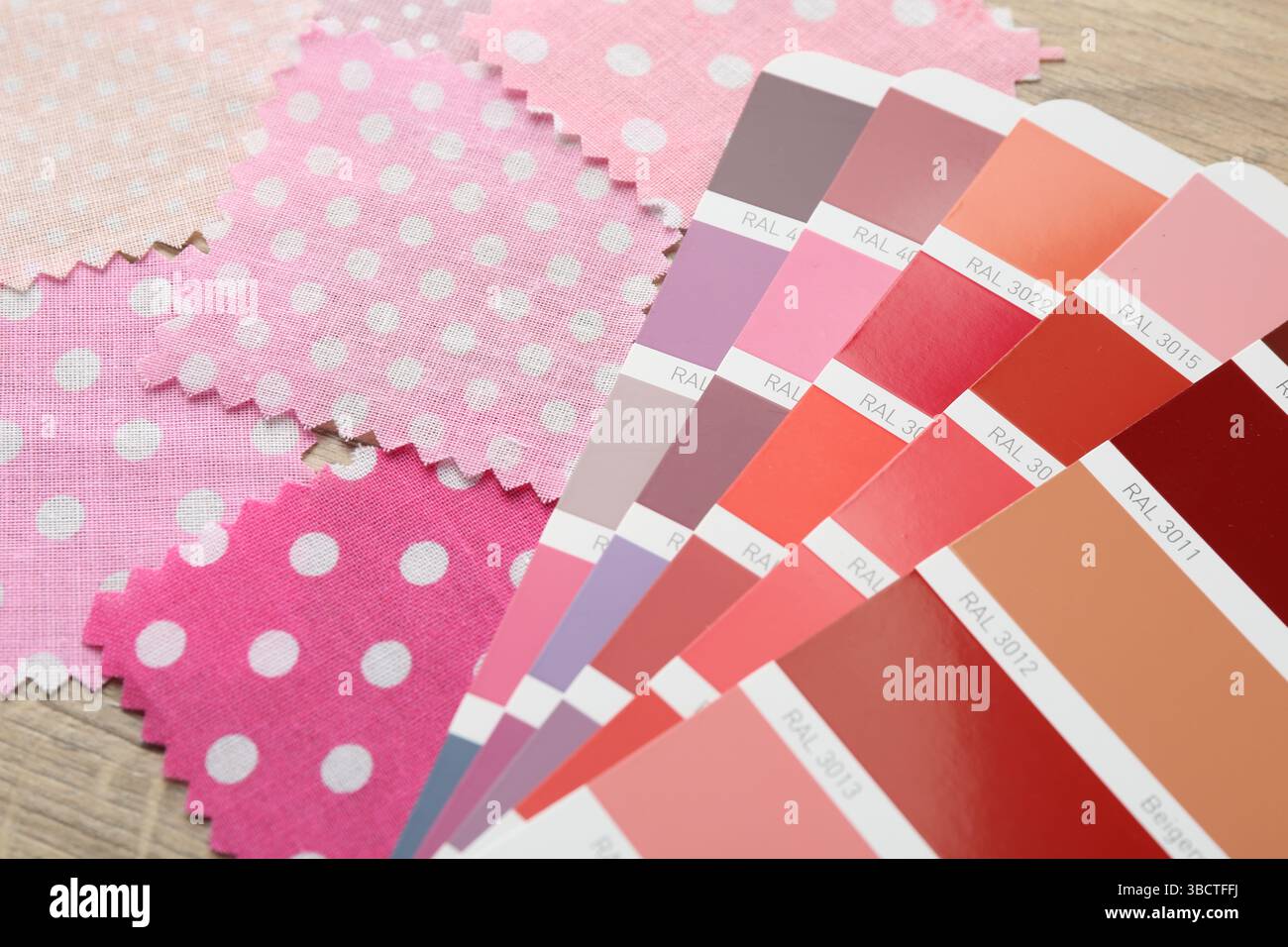 Samples of colorful fabrics and color palettes on wooden table, closeup ...