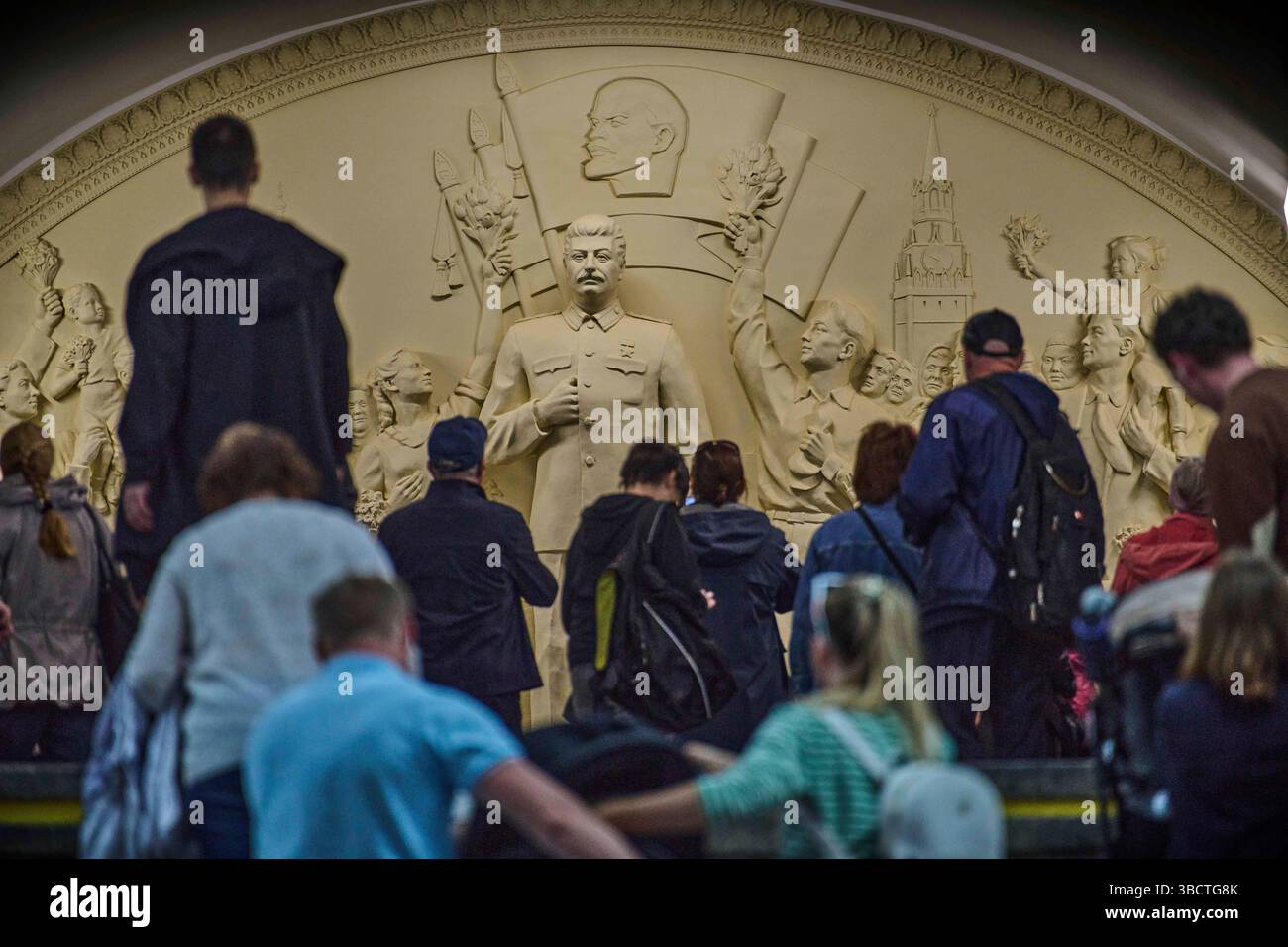 Passengers walk along the passage between stations walking in front of ...