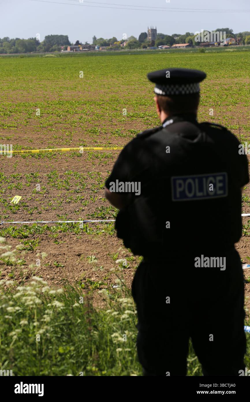 Wisbech, Norfolk, UK. 21st May, 2025. A police officer guards the ...