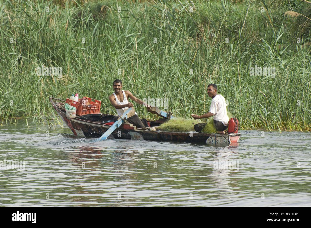 Two fishermen with nets in a small row boat, River Nile, Egypt, Africa ...
