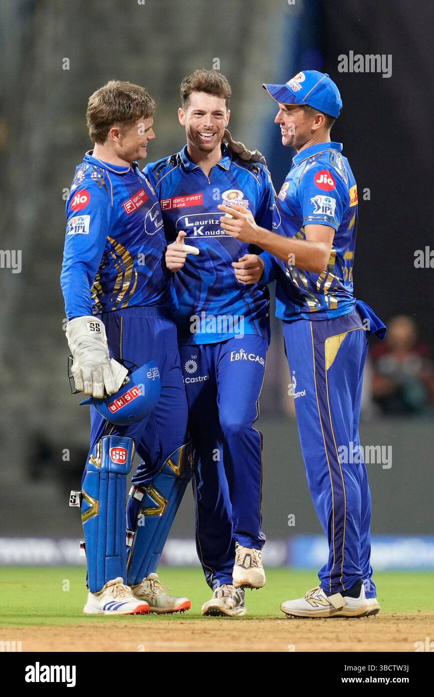Mumbai Indians' Mitchell Santner, center, Ryan Rickelton, left, and Trent Boult celebrate the ...