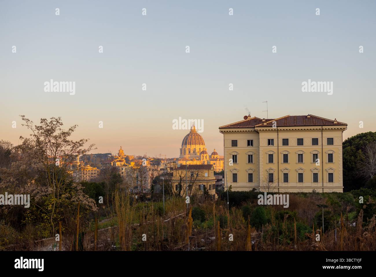 A scenic view of the dome of St Peters Basilica in Rome glowing in the ...