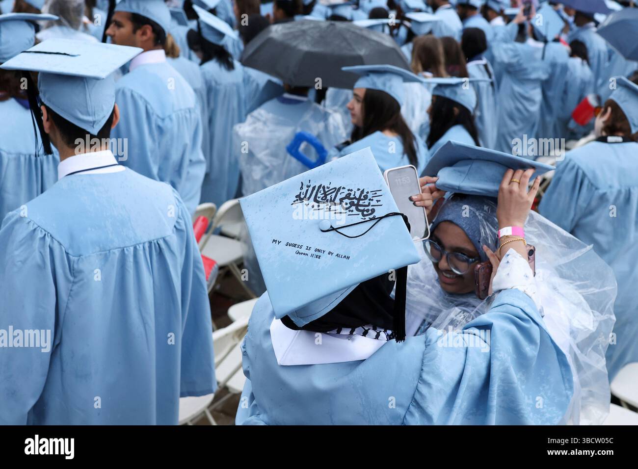 Students adjust their caps during the Columbia University commencement ...