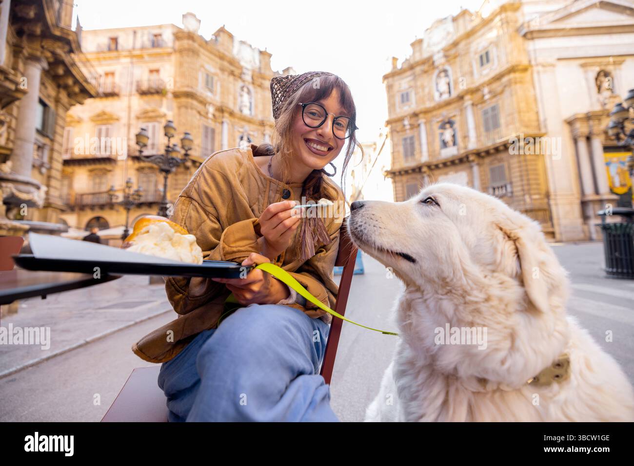 A woman shares a sweet moment with her dog while enjoying a traditional ...