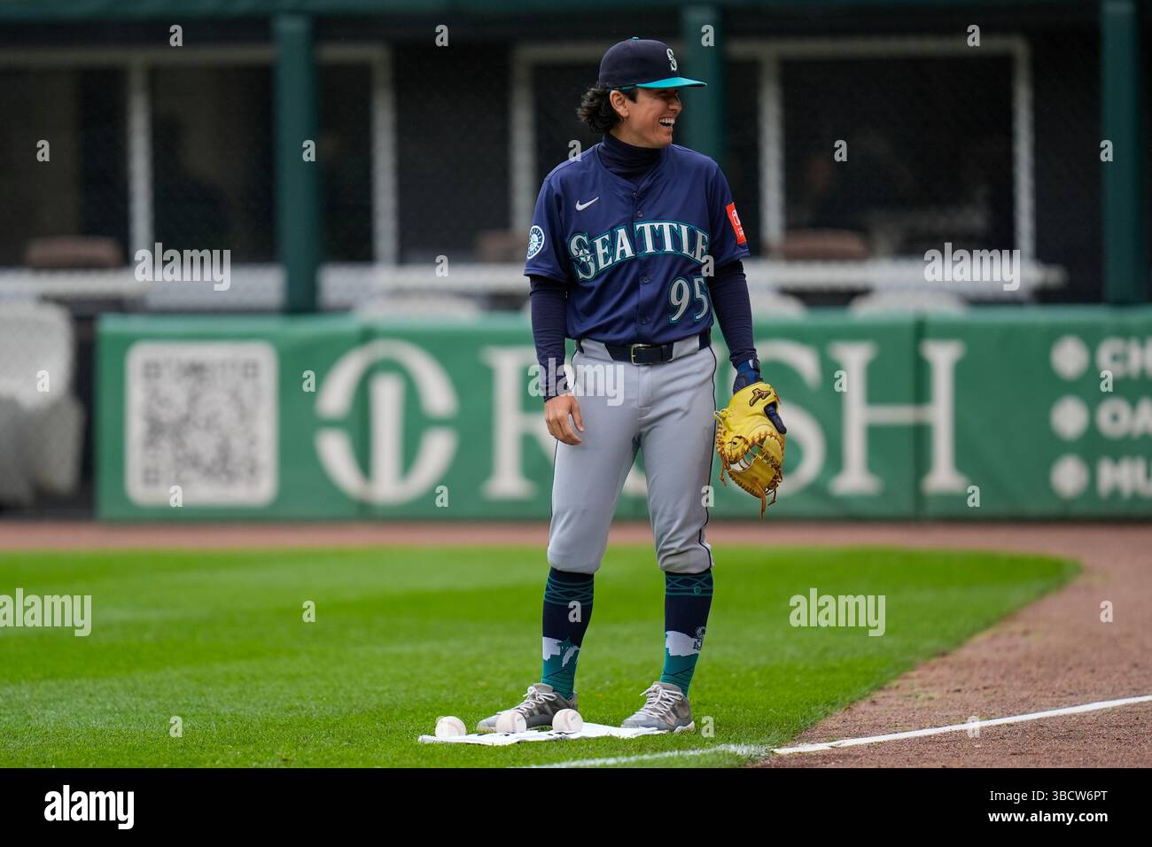 Seattle Mariners' Justin Novak (95) smiles at fans as he warms up ...