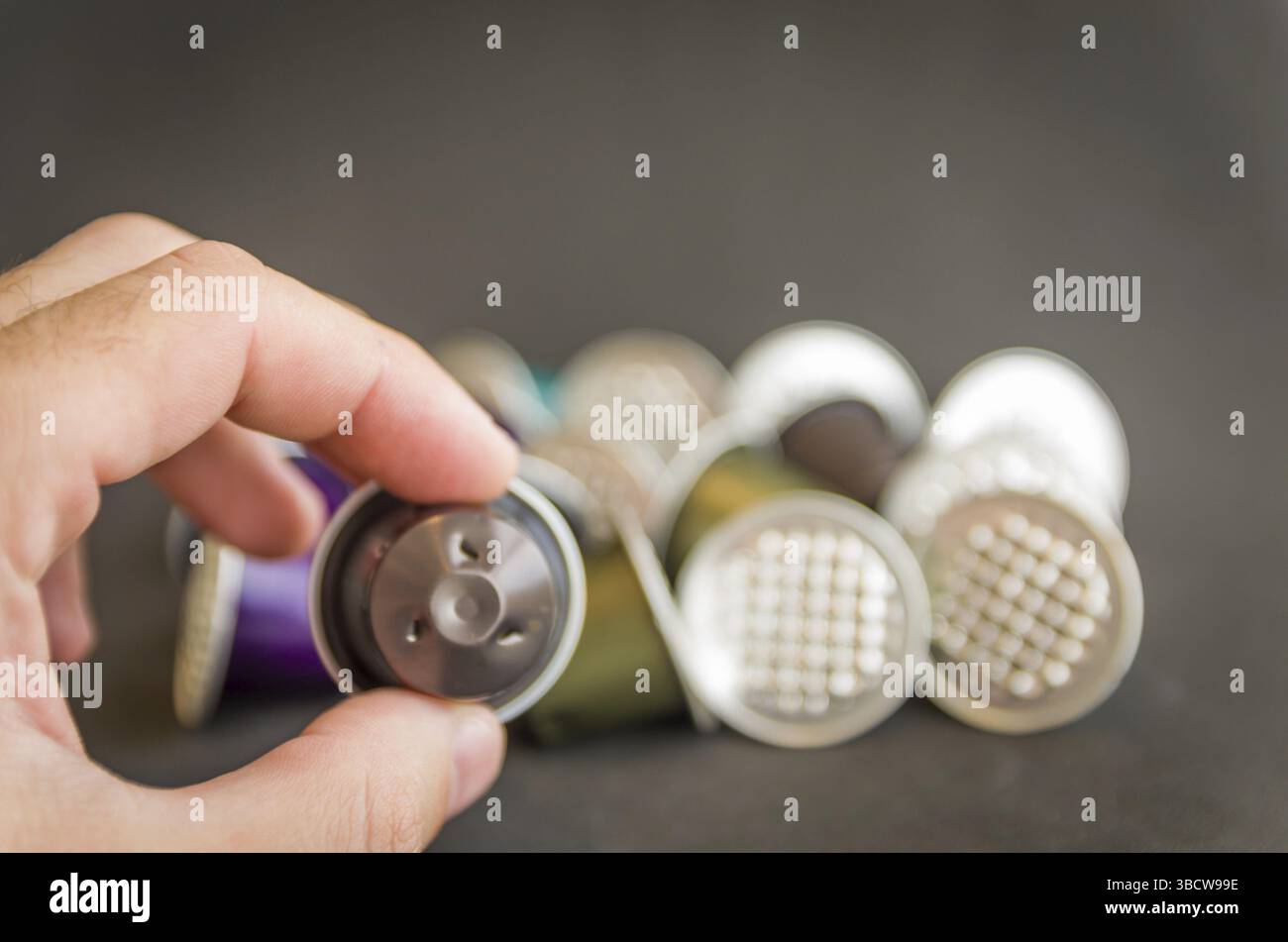 Colorful espresso coffee capsules used on black background, recycling ...