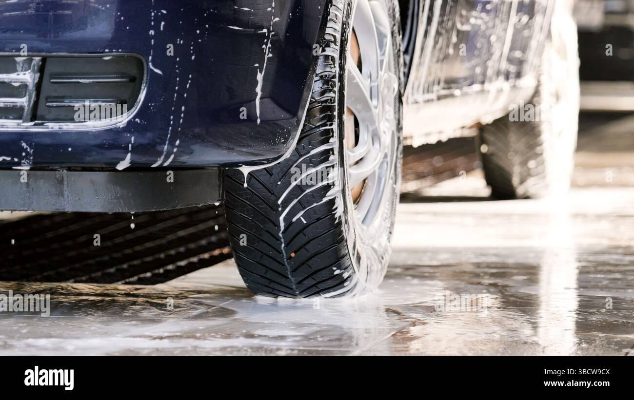 Droplets of detergent drip off the body of a passenger car Stock Photo ...