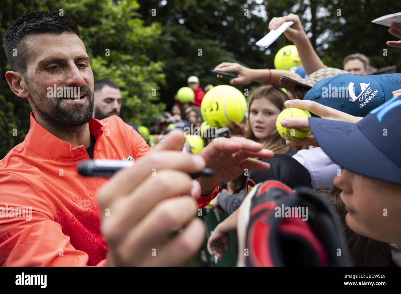 Serbia's Novak Djokovic signs autographs after winning a game against ...