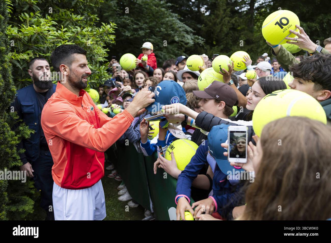 Serbia's Novak Djokovic signs autographs after winning a game against ...