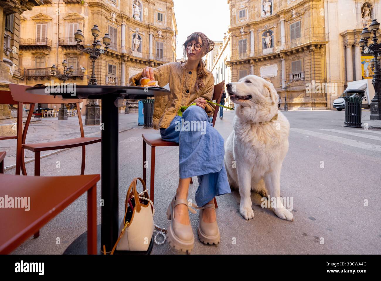 A woman shares a sweet moment with her dog while enjoying a traditional ...