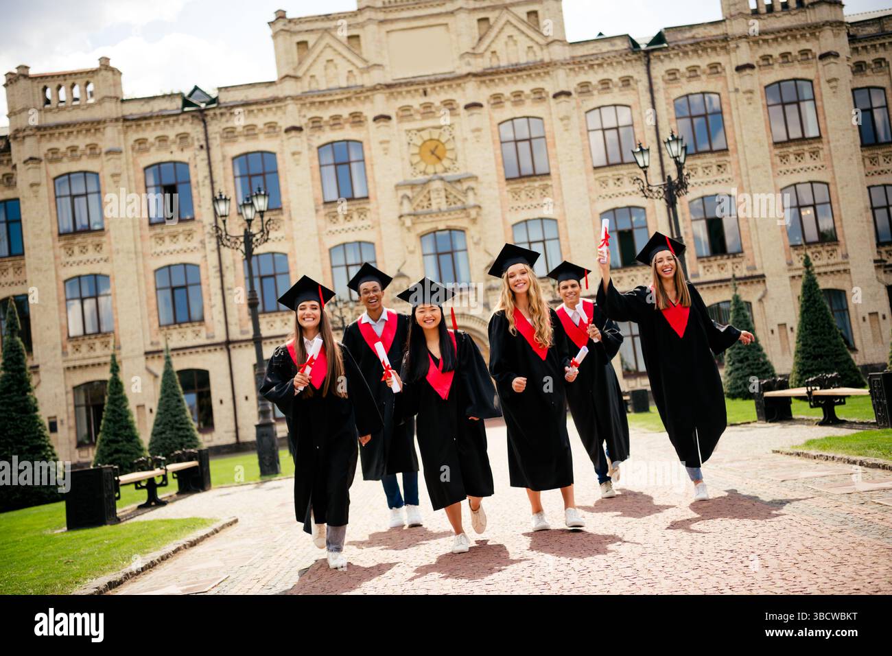 Full body portrait of group students running hold diploma mortarboard ...