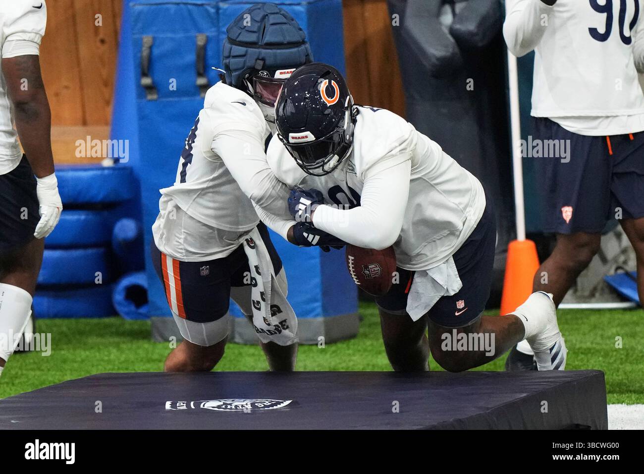 Chicago Bears defensive lines Austin Booker, left, works with Gervon ...