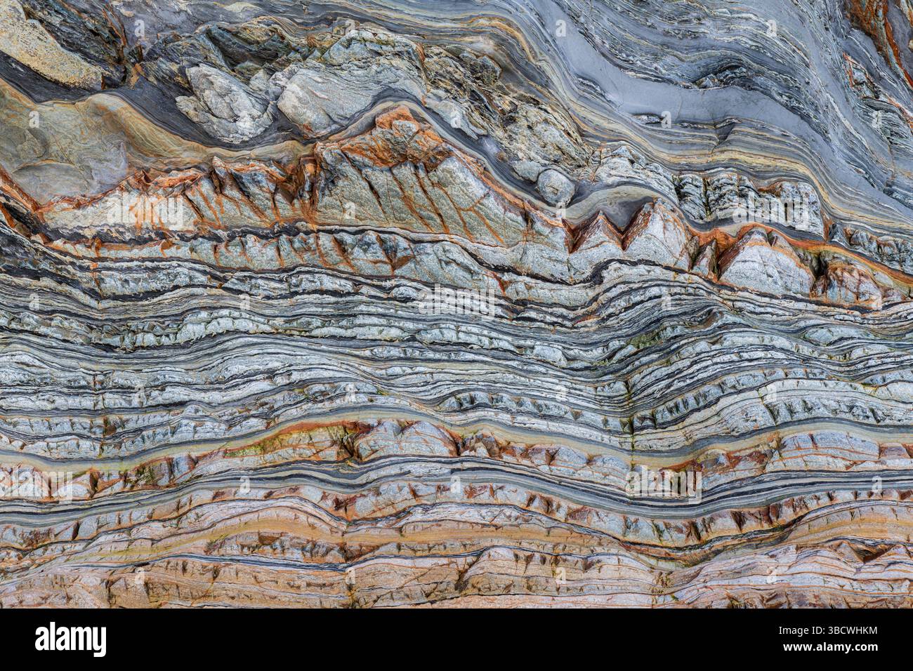 Spain, Barrika. Contorted rock layers on beach Stock Photo - Alamy