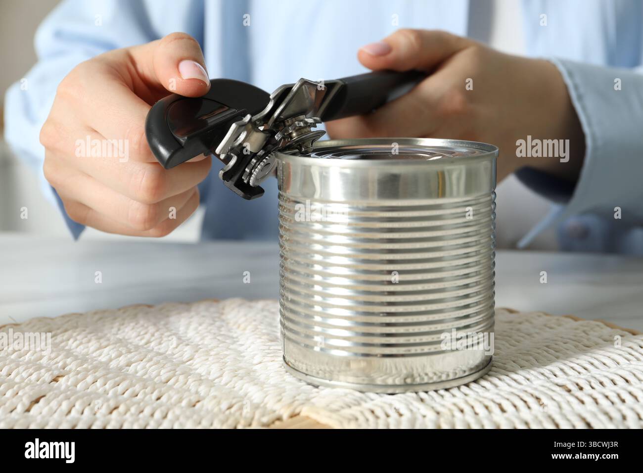 Woman opening tin can opener hi-res stock photography and images - Alamy